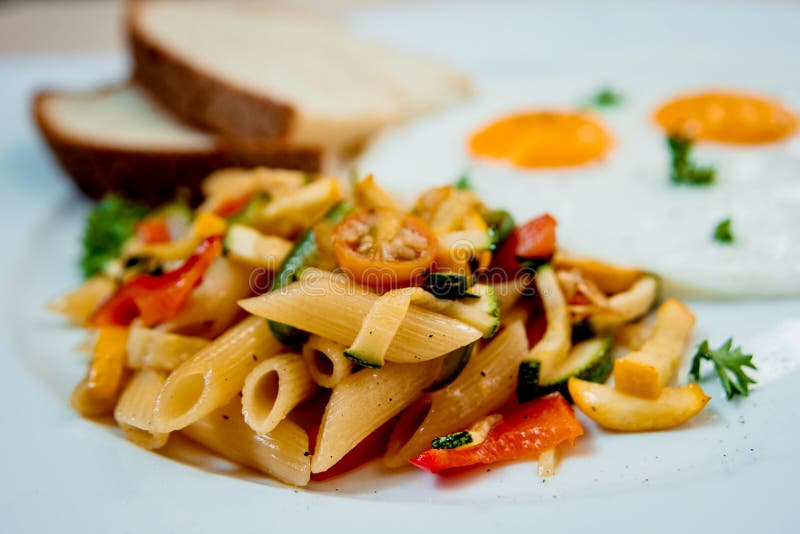 Fried Eggs with Pasta on the White Plate Stock Image - Image of ...
