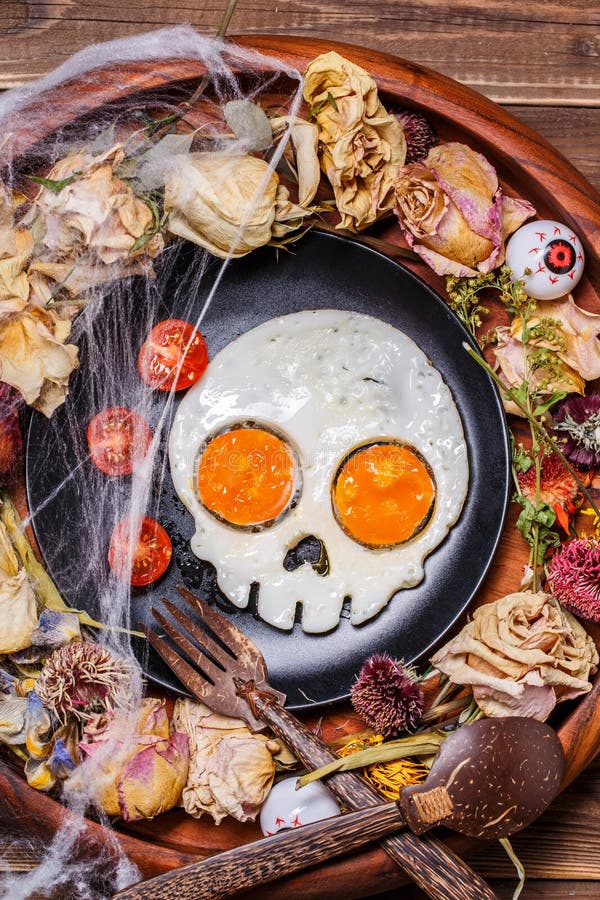 Fried Eggs in the Shape of a Skull and Fresh Tomatoes. Stock Photo ...
