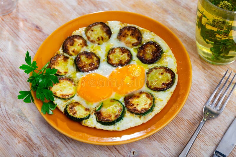 Fried Eggs with Zucchini and Herbs Stock Image - Image of laying ...