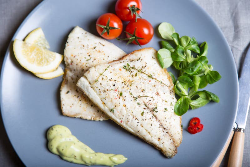 Fried Fillet Dorado Fish with Tomatoes, Lemon and Corn Salad Stock ...