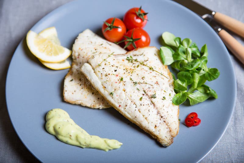 Fried Fillet Dorado Fish with Tomatoes, Lemon and Corn Salad Stock ...