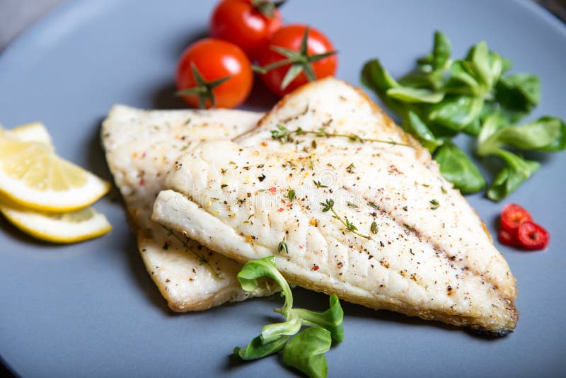 Fried Fillet Dorado Fish with Tomatoes, Lemon and Corn Salad Stock ...