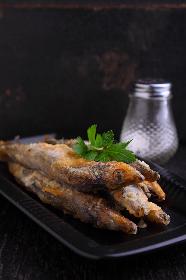Fried Fish Capelin in a Black Plate Stock Image - Image of healthy ...
