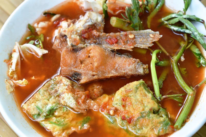 Fried Fish and Egg Stuffed Climbing Wattle in Spicy Sour Soup on Bowl ...