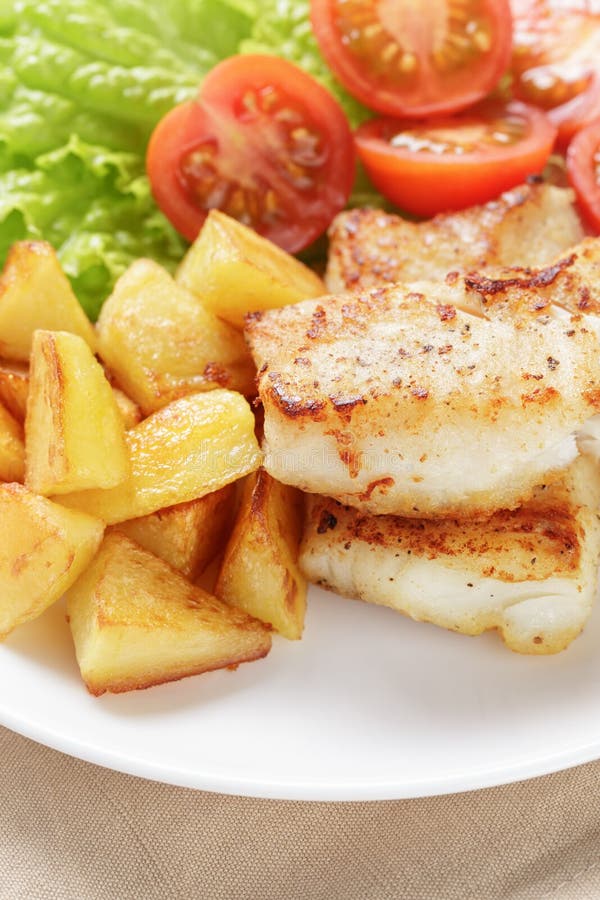 Fried Fish Fillet with Vegetables on Wood Table Stock Photo - Image of ...