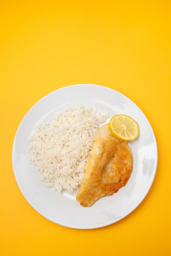 Fried Fish Fillets with Rice and Lemon on Plate Stock Photo - Image of ...