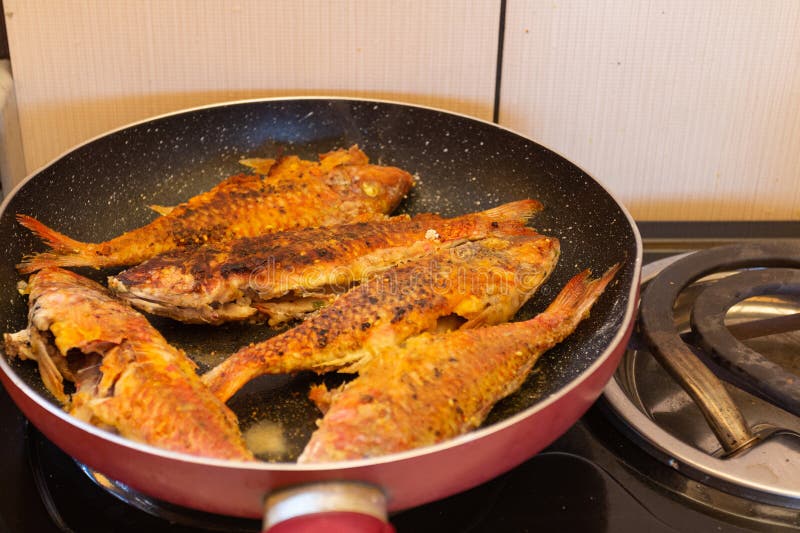 Fried Fish in a Frying Pan on a Gas Stove in the Kitchen Stock Photo ...