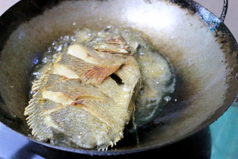 Fried Fish in a Frying Pan in the Kitchen Stock Photo - Image of ...