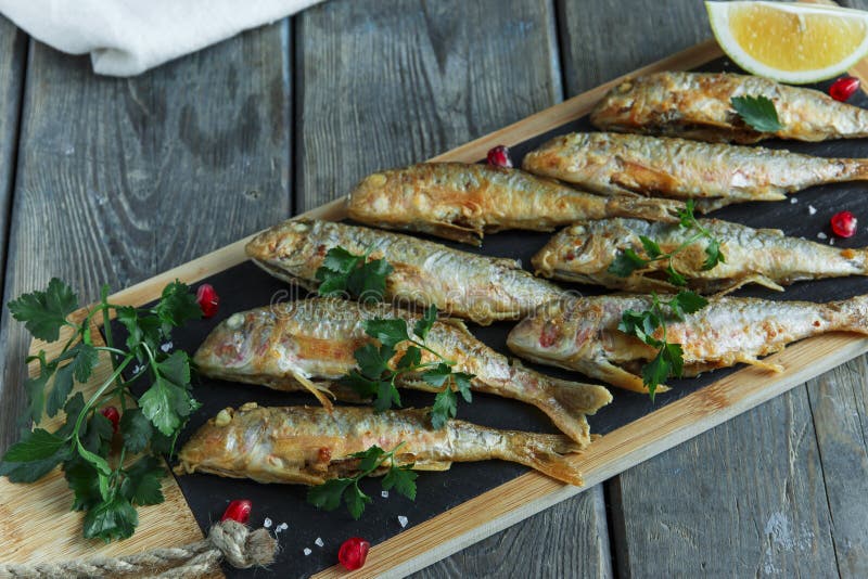 Grilled Surmullet Fish Wrapped in Bacon on White Plate. Close-up Stock ...