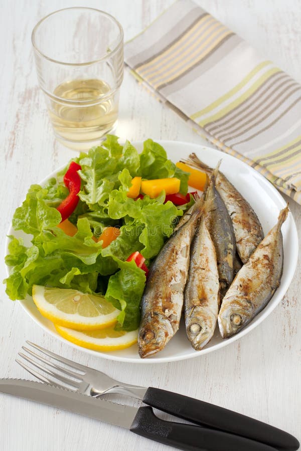 Fried fish with lemon stock image. Image of sardine, plate - 23024421