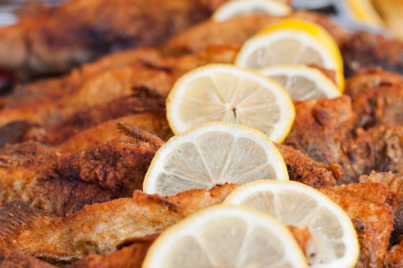 A Slice Of Fried Fish With Lemon Stock Photo - Image of seafood, green ...