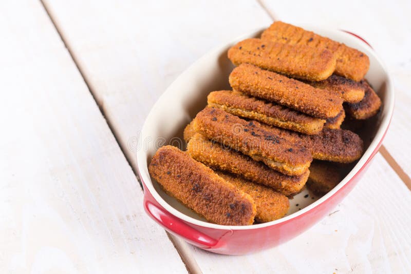 Fried Fish Meat Sticks in the Bowl Above Wooden Table Stock Image ...