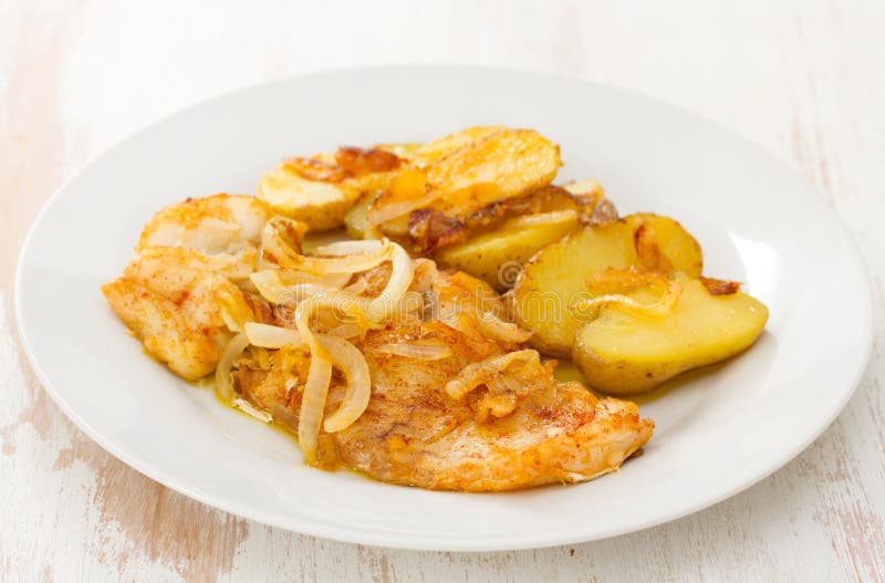 Fried Fish with Onion and Potato on Dish Stock Photo - Image of plate ...