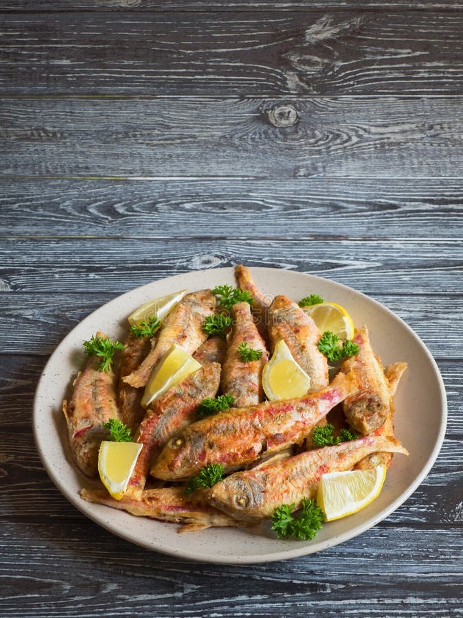 Grilled Surmullet Fish Wrapped in Bacon on White Plate. Close-up Stock ...