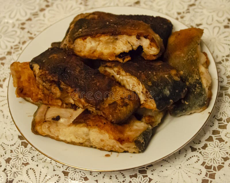 Fried fish on a plate stock photo. Image of plate, cooking - 240703378