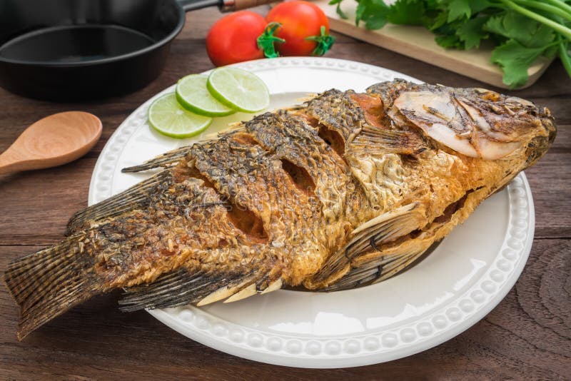 Fried Fish on Plate with Vegetables and Pan Stock Image - Image of ...