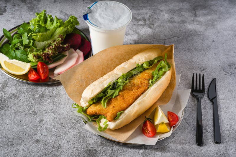 Fried Fish Sandwich with Greens on the Stone Table. Turkish Name Balik ...