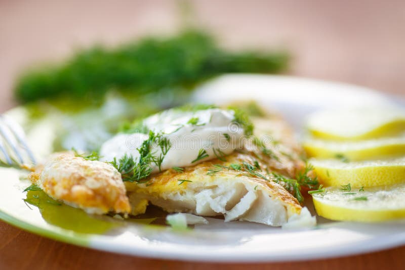 Grilled Fish with Fried Potatoes and Salad Top View, Closeup Stock ...