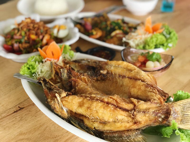 Fried Fish with Sauce and Vegetable on Wooden Table, Thai Food Stock ...