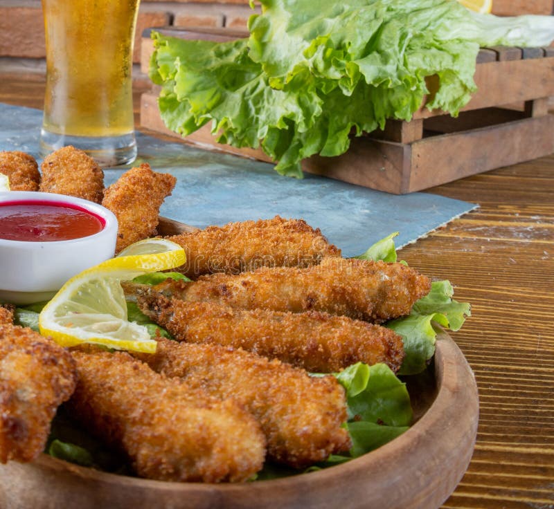 Fried Fish Served in a Plate with Lettuce, Vertical Stock Image - Image ...