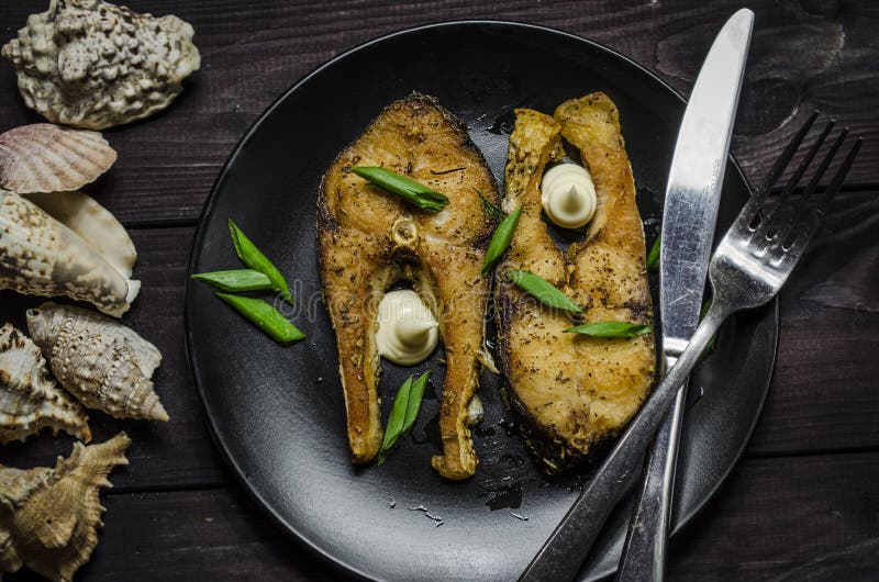 Fried fish steaks stock image. Image of greens, sauce - 112424103
