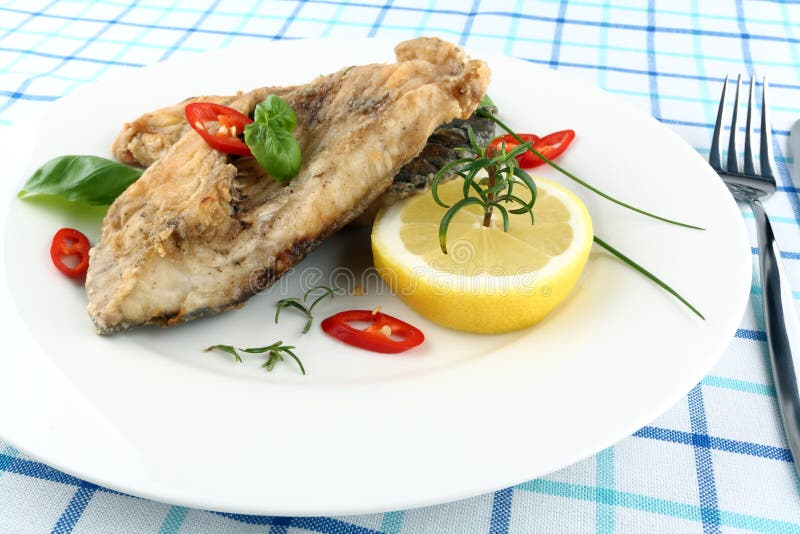 Fried Fish on White Plate with Fork and Knife Stock Photo - Image of ...