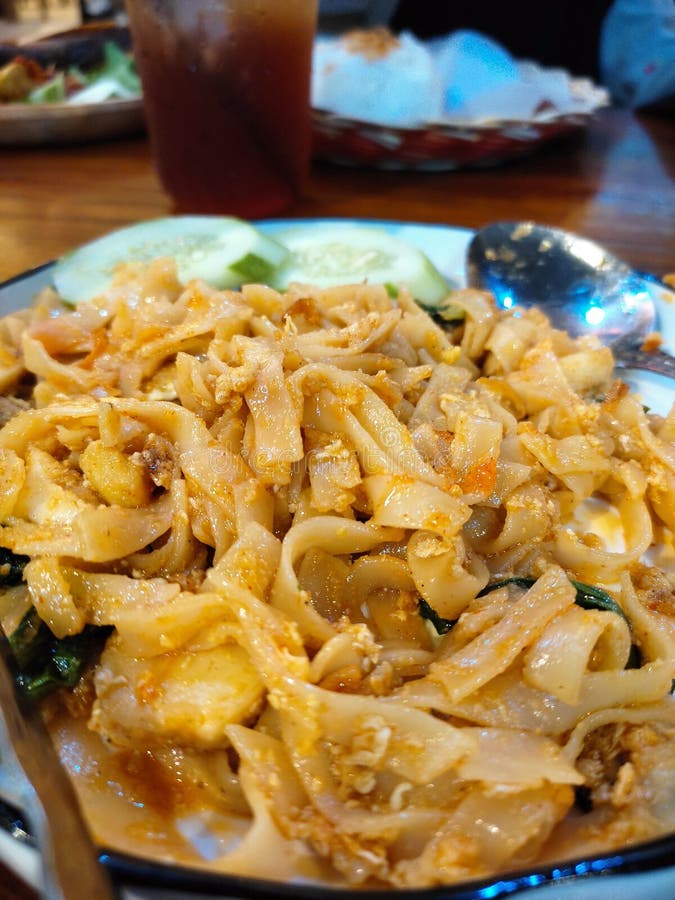 Fried Flat Noodle Served with Sliced Cucumber Stock Image - Image of ...