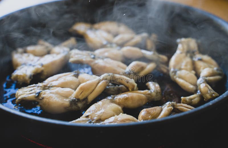 Fried frog legs on pan stock photo. Image of cookery - 212725460