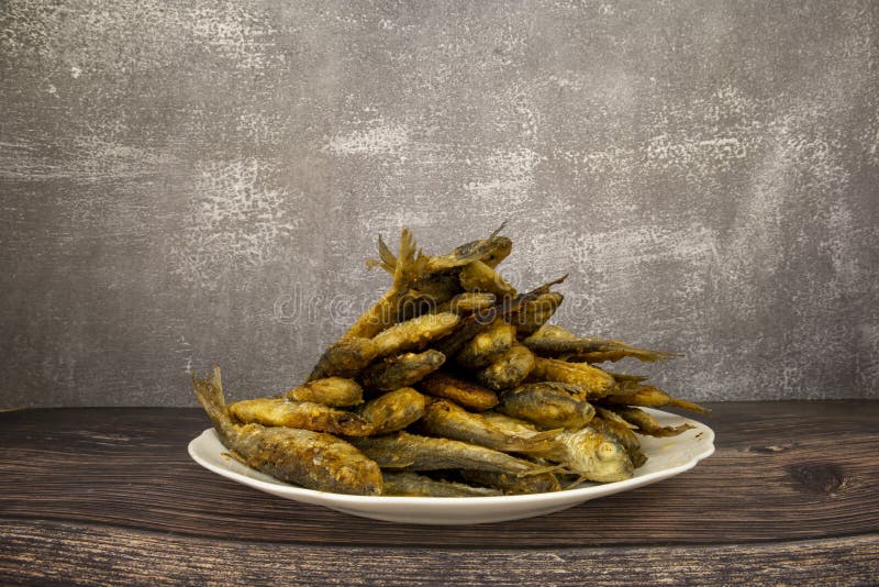 Fried herring on a plate stock photo. Image of meal - 262383538