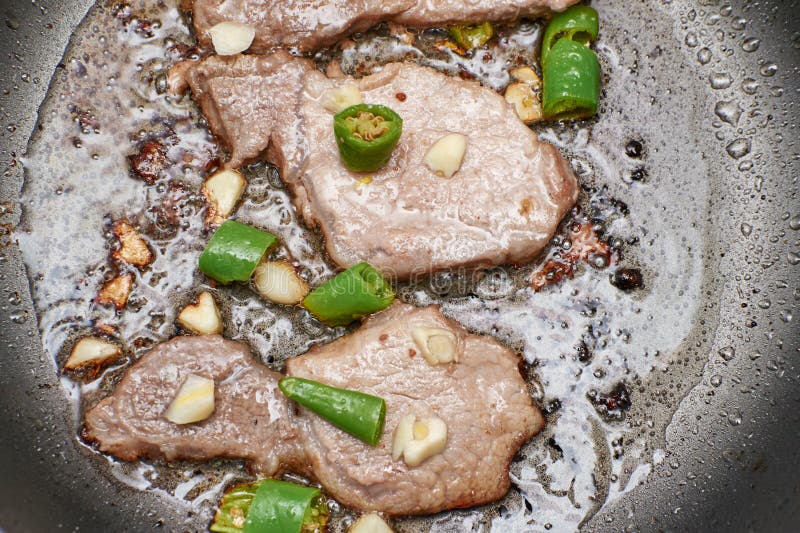 Fried meat in a frying pan stock photo. Image of healthy - 64329610