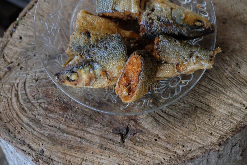 Fried Milkfish on a Plate on Wooden Table Stock Photo - Image of ...