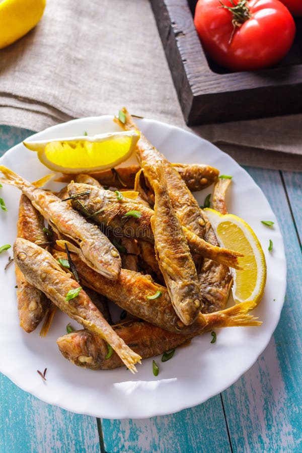 Fried Mullet with Lemon and Herbs on a Ceramic Plate Stock Photo ...