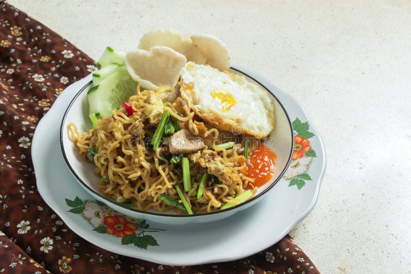 Fried Noodles on a Round White Plate with a Brown Patterned Cloth Stock ...