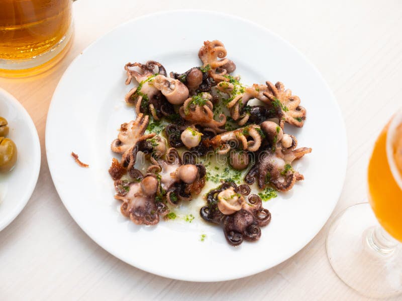 Fried Octopus Dish with Herbs and Sauce and Beer Closeup Stock Image ...