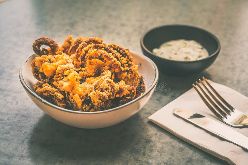 Fried Octopus Tentacles in a Bowl with Tartar Sauce on the Side Stock ...