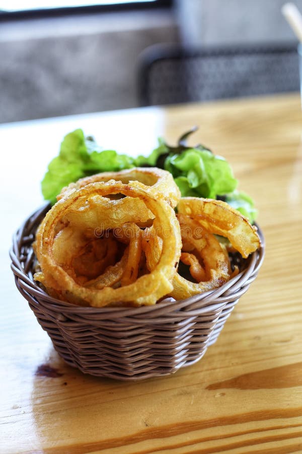 Fried Onion Rings in Wicker Basket on Wooden Table Stock Photo - Image ...