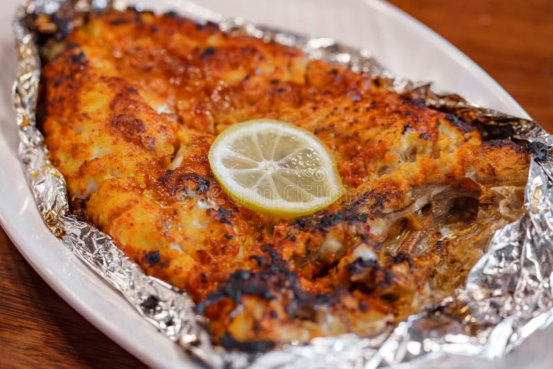 Fried Parrot Fish Cooked in Foil with Lemon, Close-up, Selective Focus ...