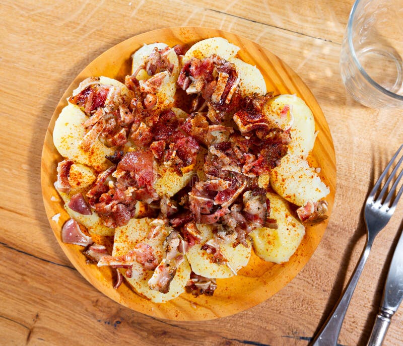 Fried Pigs Ear with Red Pepper and Potatoes at Plate Stock Photo ...