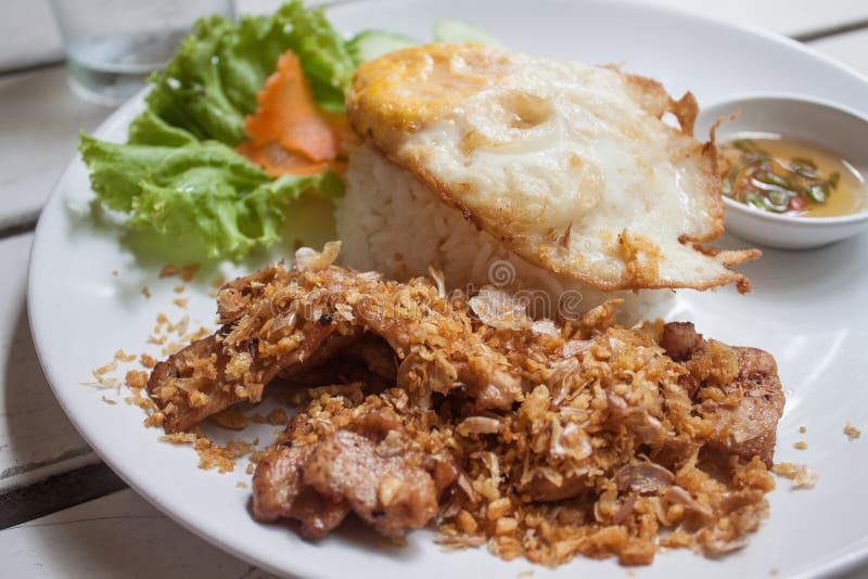 Fried Pork with Crispy Garlic on Rice + Fried Egg Stock Image - Image ...