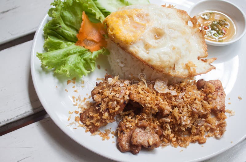 Fried Pork with Crispy Garlic on Rice + Fried Egg Stock Photo - Image ...