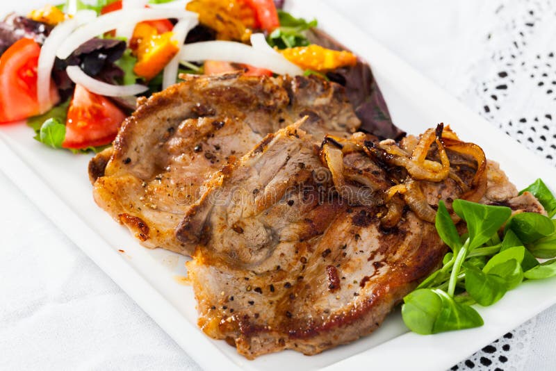 Fried Pork Meat Chops with Salad of Fried Orange and Vegetables Stock ...
