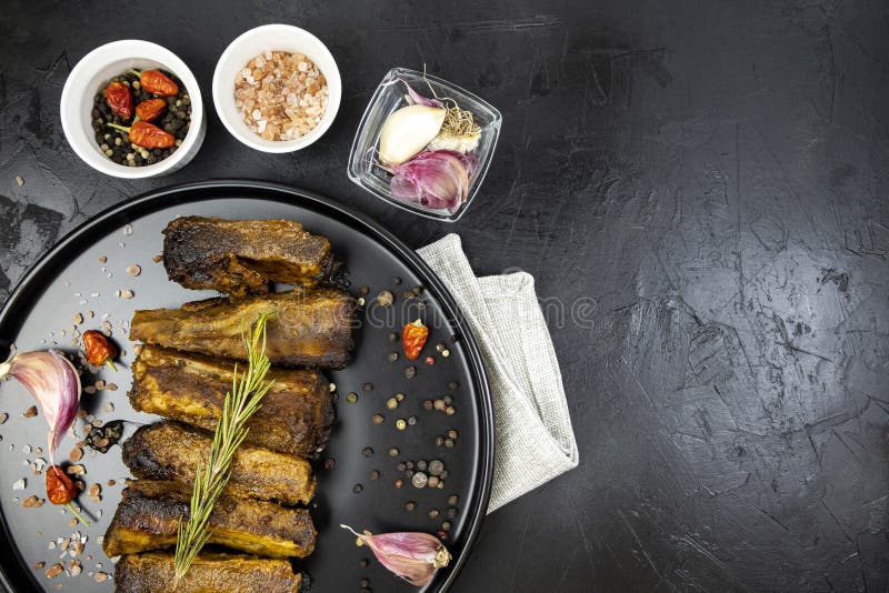 Fried Pork Ribs with Seasonings and Spices on a Black Table, Menu ...