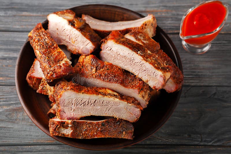 Fried Pork Ribs Served on a Plate with Tomatoes and Ketchup Stock Photo ...