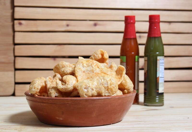 Fried Pork Skins with Hot Sauce in Rustic Kitchen Stock Photo - Image ...