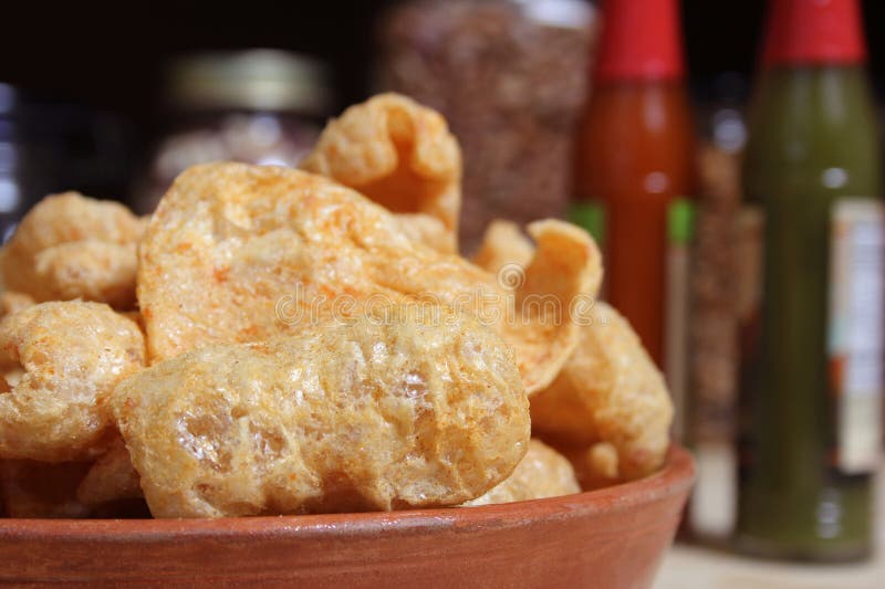 Fried Pork Skins with Hot Sauce in Rustic Kitchen Stock Photo - Image ...