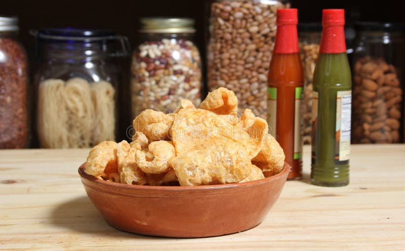 Fried Pork Skins with Hot Sauce in Rustic Kitchen Stock Photo - Image ...