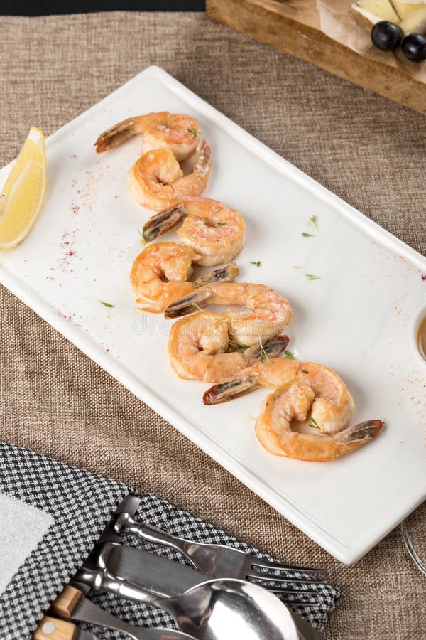 Fried Prawns Shrimps and Lemon Slice on White Plate on the Table at ...