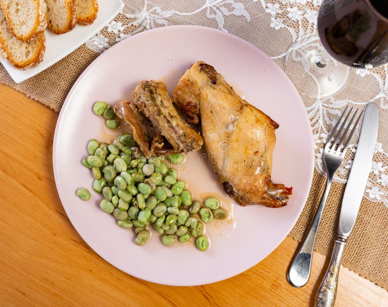 Fried Rabbit on a Plate with Beans and Parsley Stock Photo - Image of ...