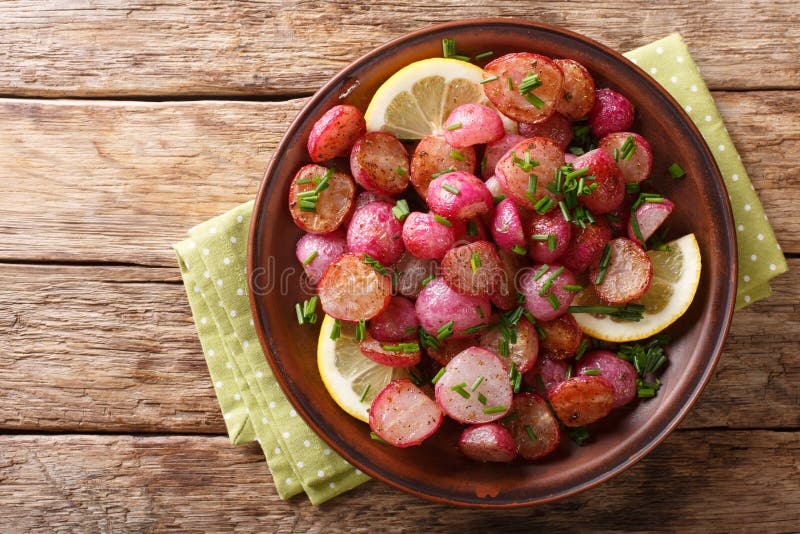 Fried Radish with Lemon and Green Onions Close-up on a Plate ...