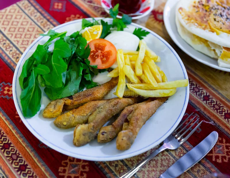 Fried Red Mullet with Vegetable Garnish in Turkish Restaurant Stock ...